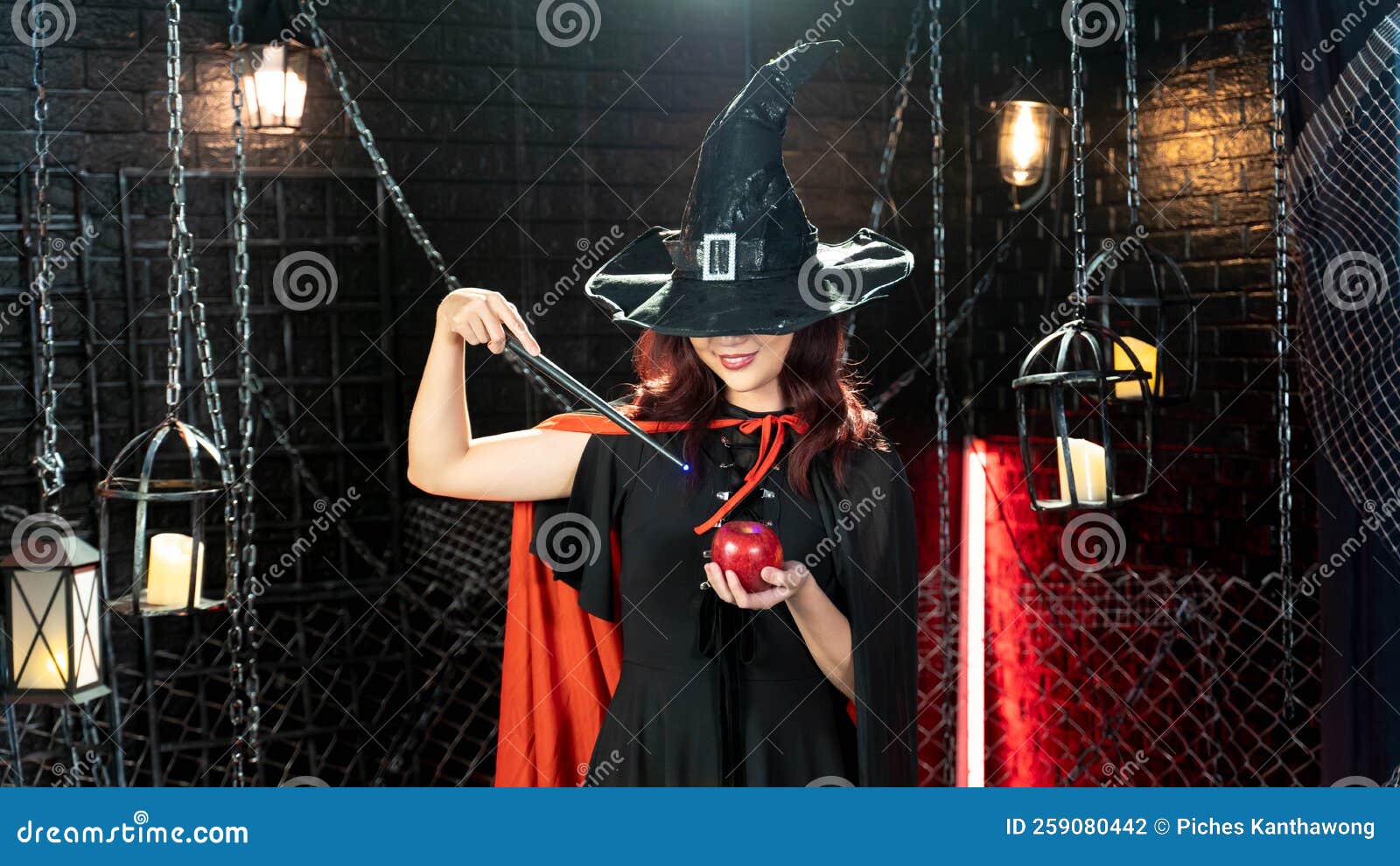 Halloween Girl Wearing Witch Costume With A Hat Using Magic Wand With