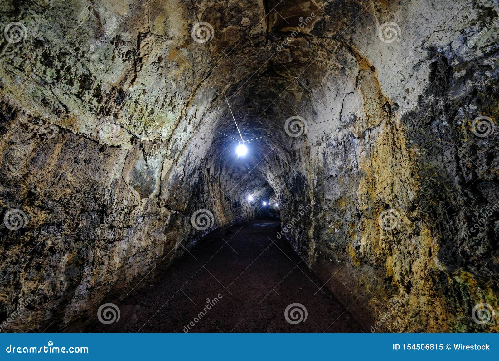 Hallway in a Cave with Lights Hanging from the Ceiling Stock Image ...