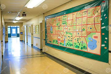 A Hallway Featuring a School Map Hanging on the Wall for Navigation and ...