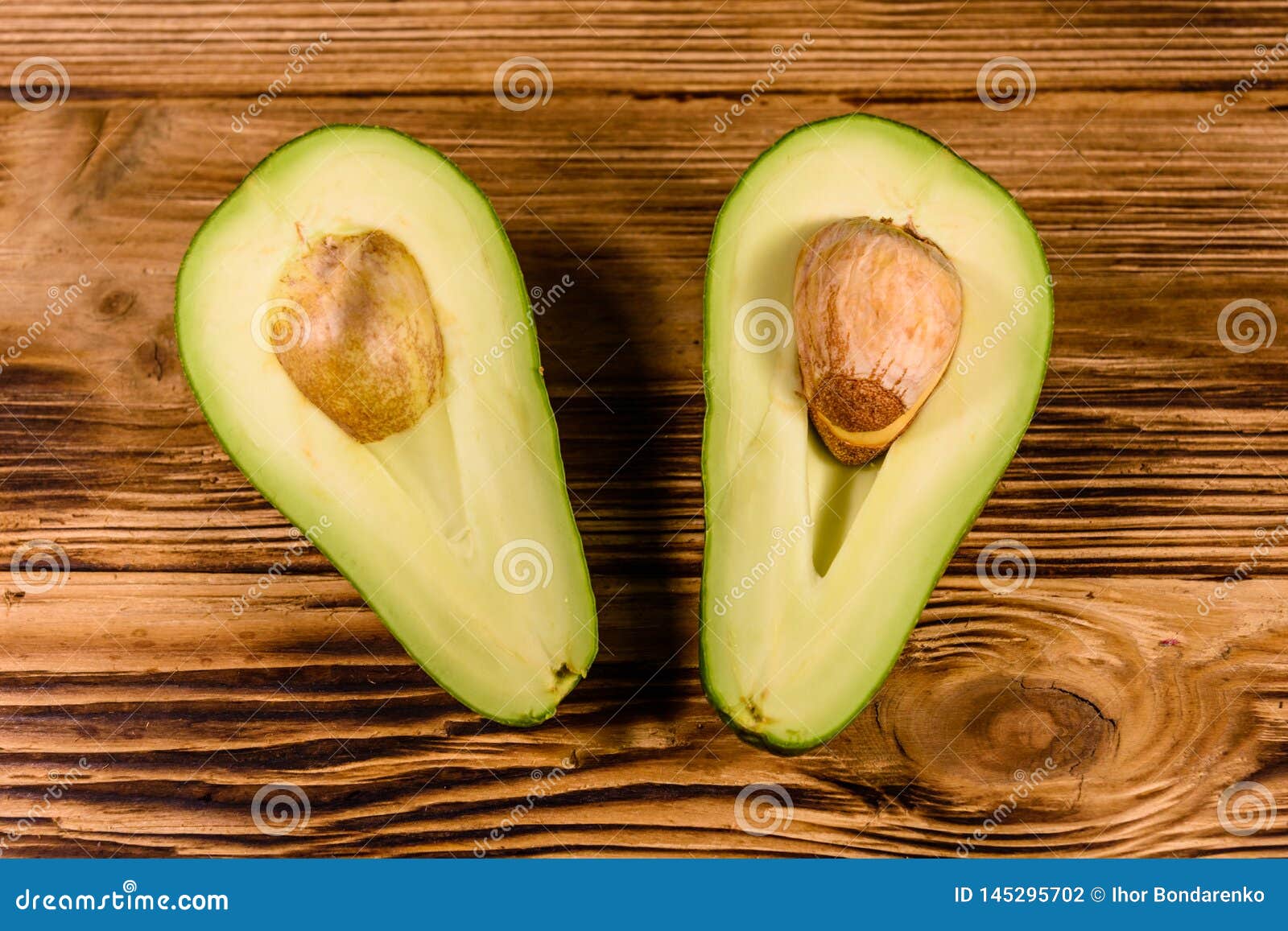 Halved Avocado Fruit on a Wooden Table. Top View Stock Photo - Image of ...