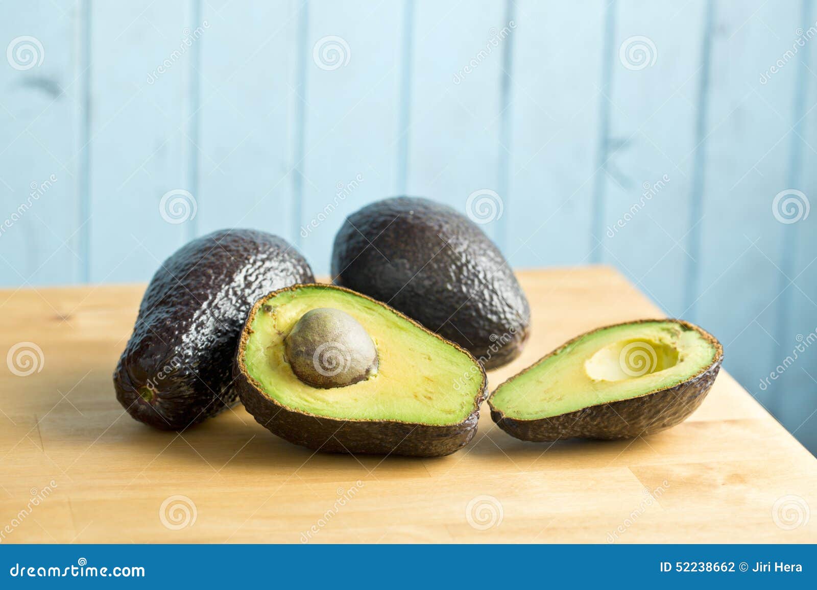 Halved Avocado on Kitchen Table Stock Photo - Image of brown, creamy ...