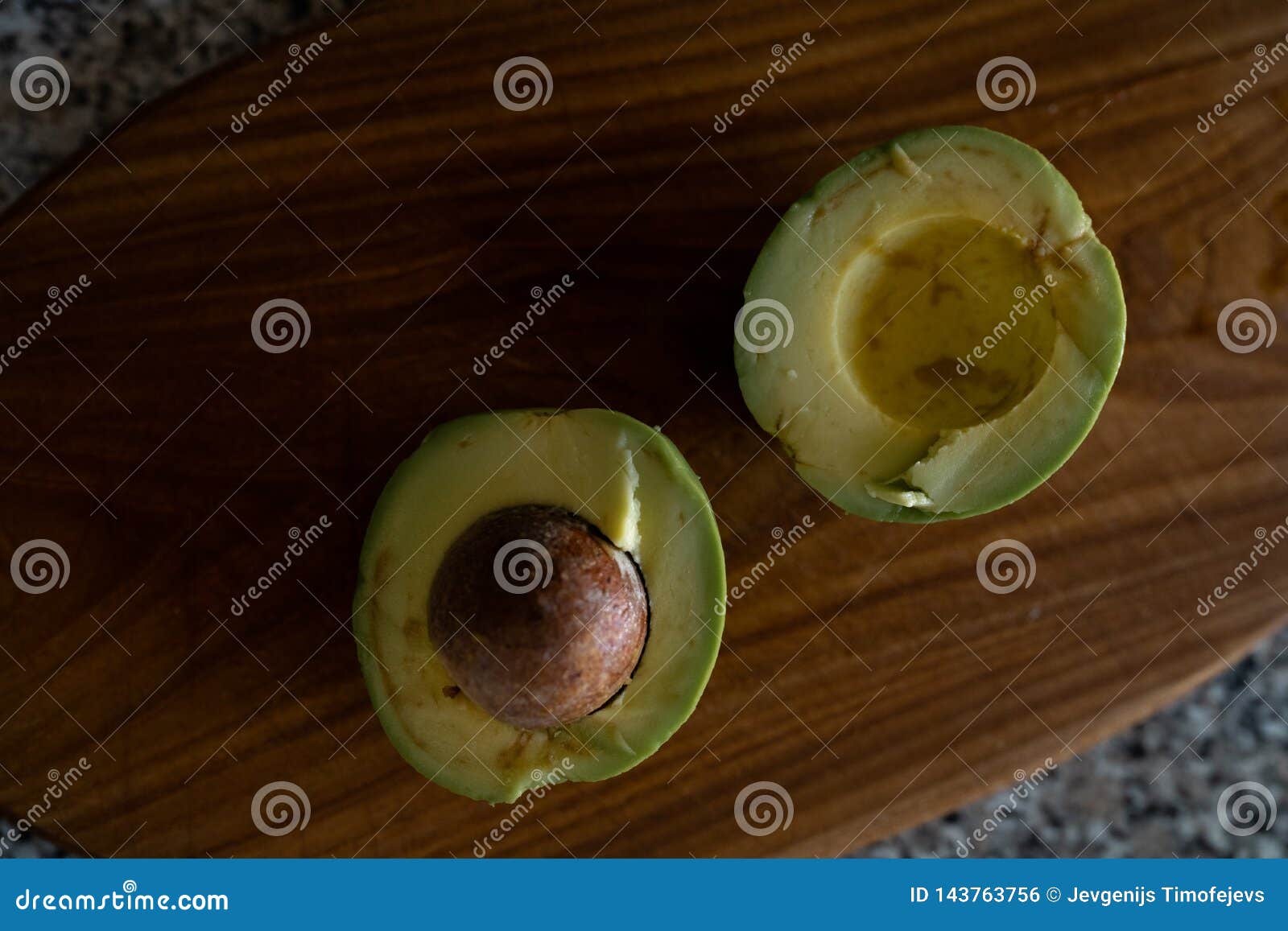 Halved Avocados - Top View of Fresh Fruit Getting Cut on a Board Stock ...