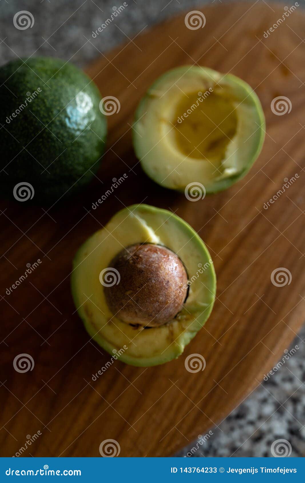 Halved Avocados - Top View of Fresh Fruit Getting Cut on a Board Stock ...