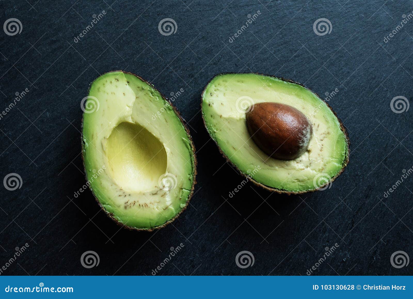 Halved Fresh Avocado on Slate Stock Photo - Image of plate, slice ...