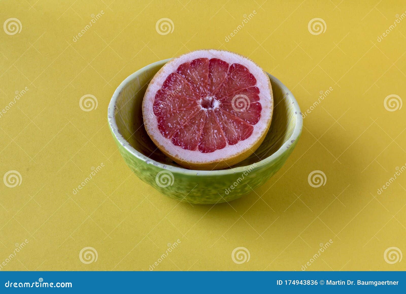 Halved Grapefruit in a Bowl Stock Photo - Image of bowl, background ...