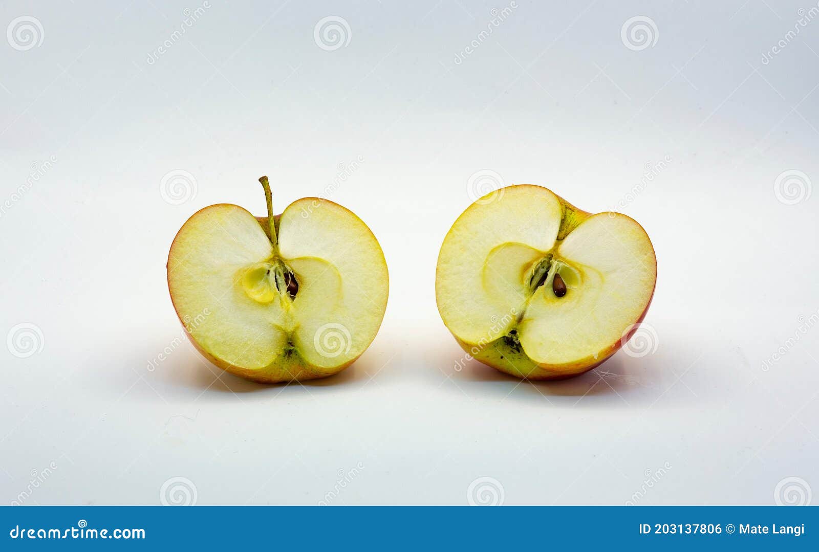 Halved red apple pieces stock photo. Image of juicy - 203137806