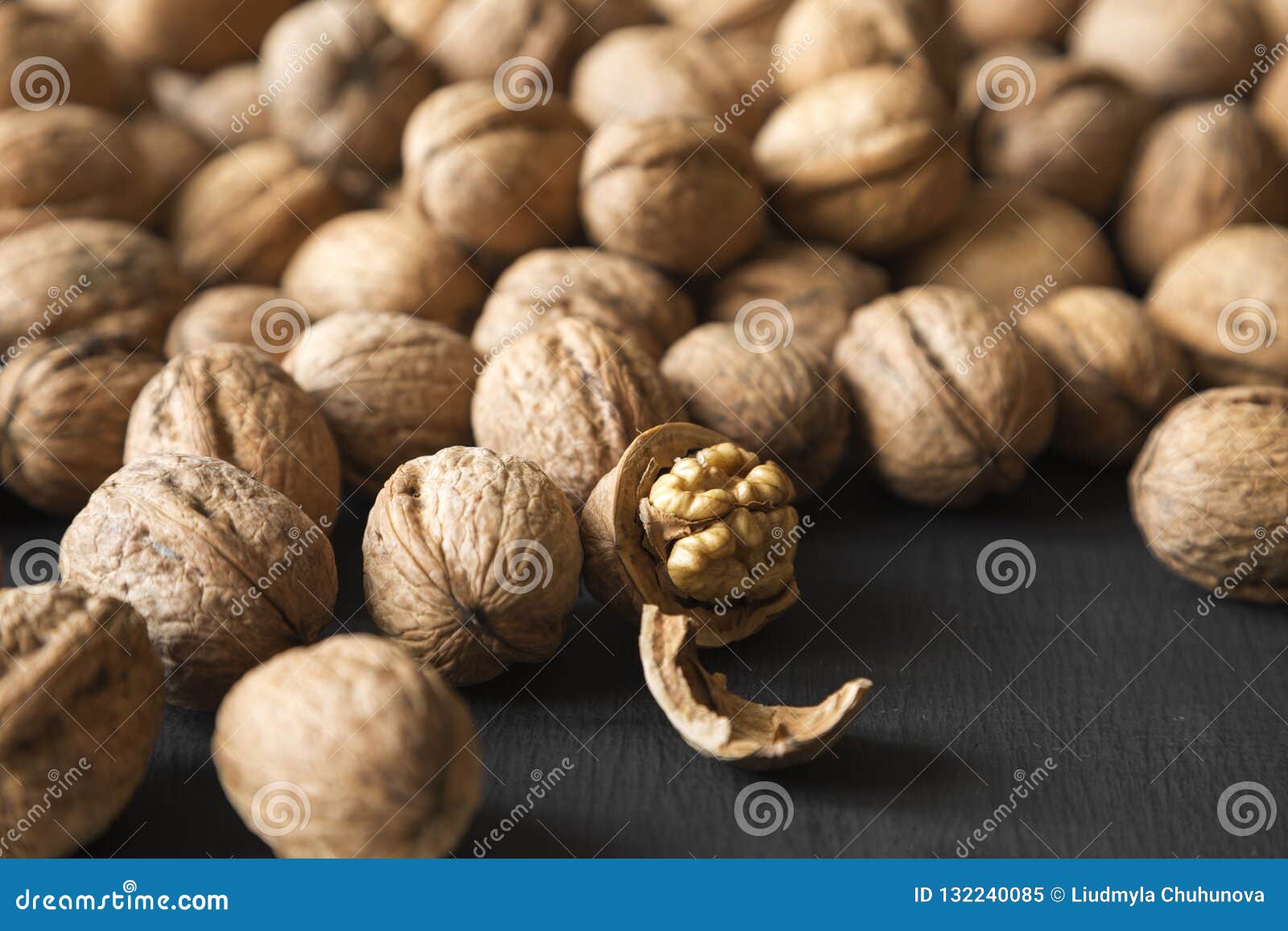 Halved and Whole Walnuts on Black Background, Side View. Close-up Stock ...