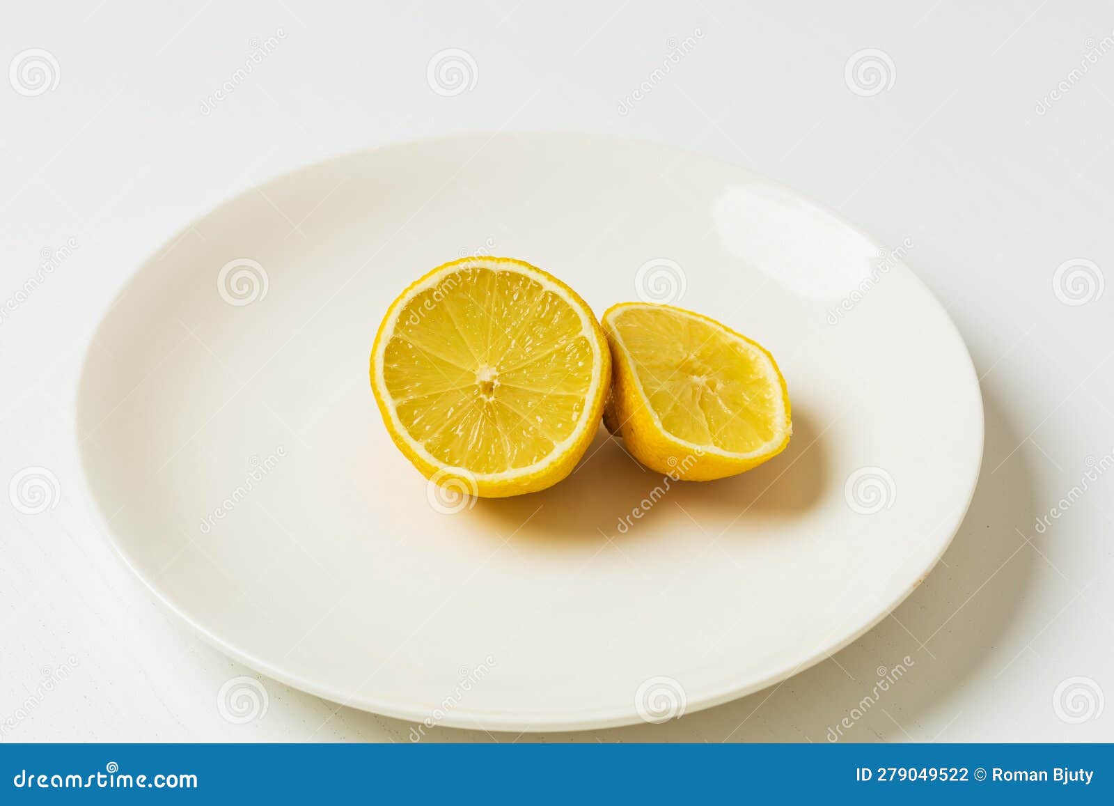 Halved Yellow Lemon on a White Plate Stock Photo - Image of sour ...
