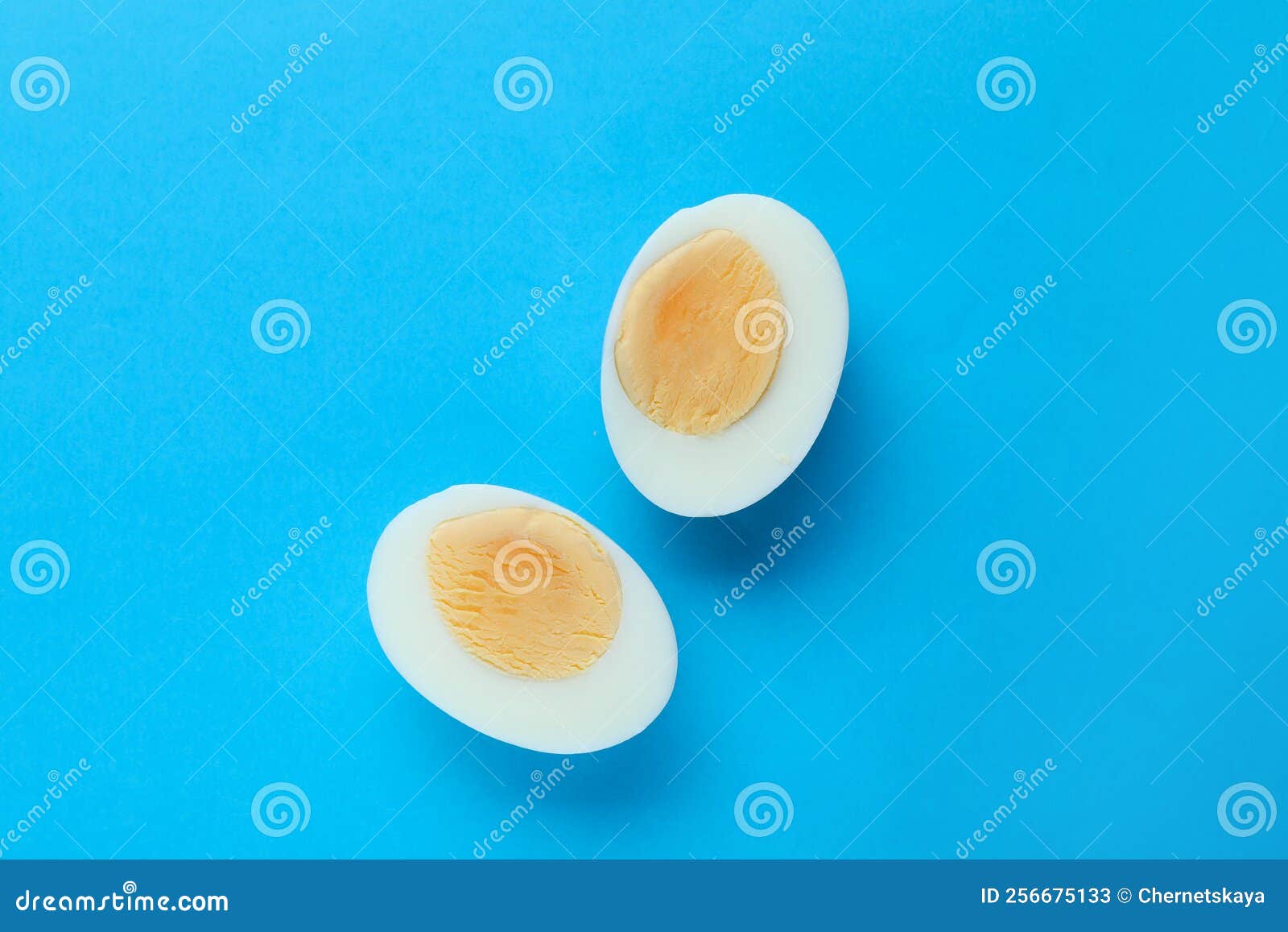 Halves of Fresh Hard Boiled Egg on Light Blue Background, Flat Lay ...