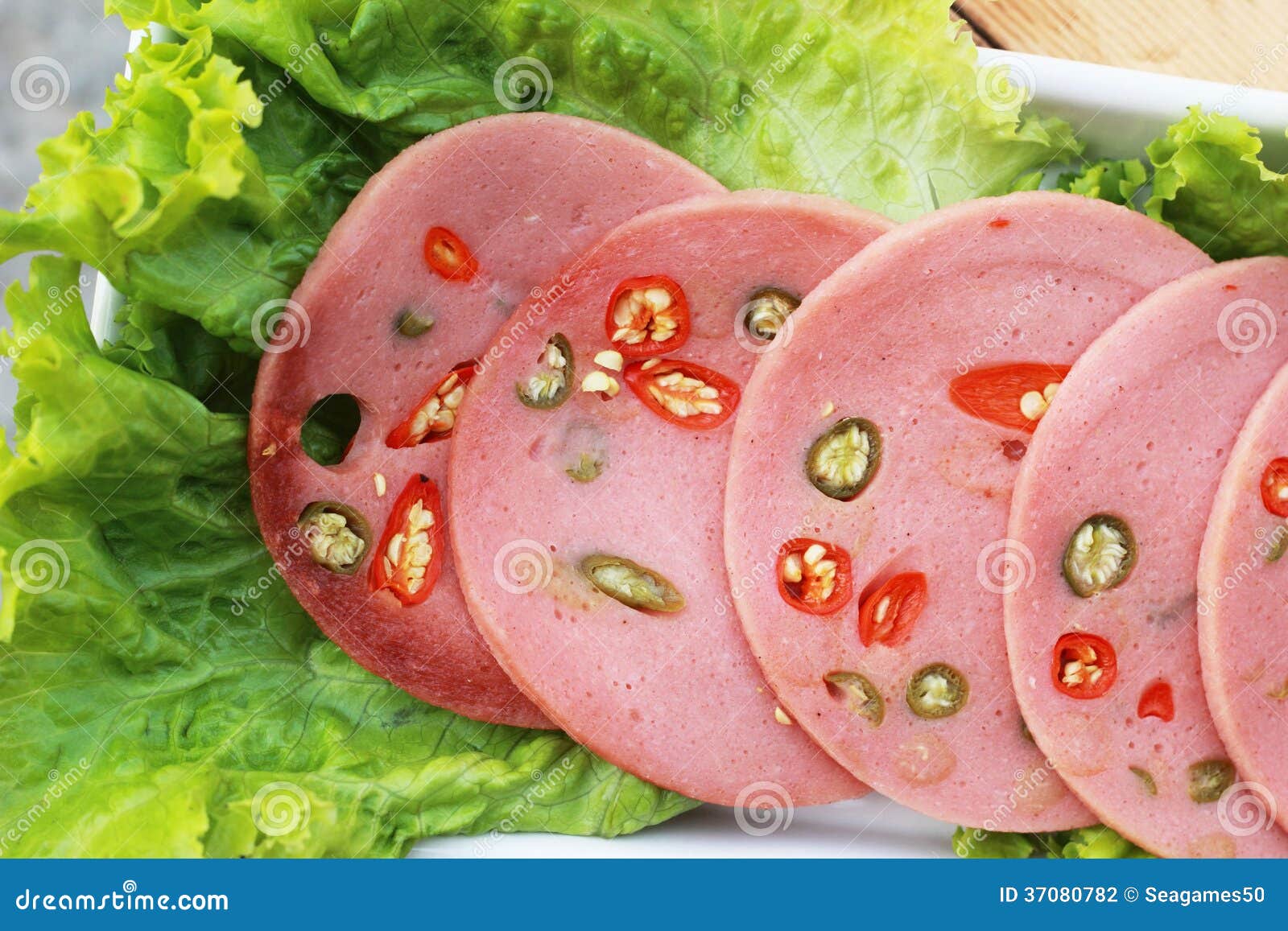 Ham Cut into Circular Discs with Red Peppers. Stock Photo - Image of ...