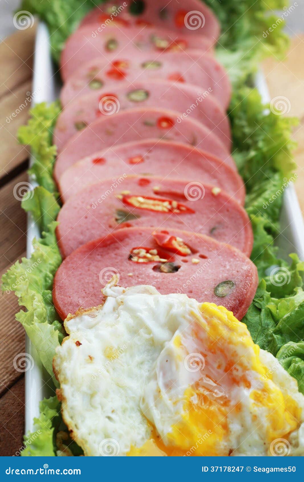 Ham Cut into Circular Discs with Red Peppers and Egg Fried. Stock Image ...