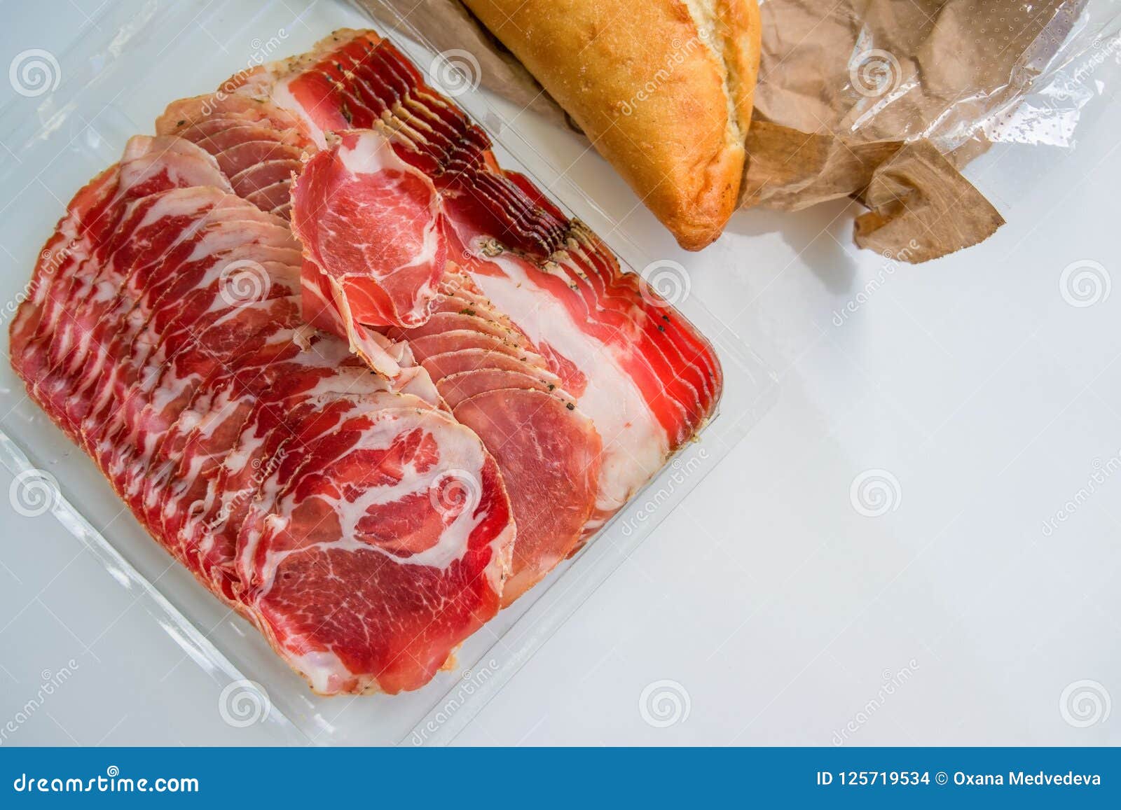 Ham and Flavor Spices, Thinly Sliced on a White Table with Bread. Stock ...