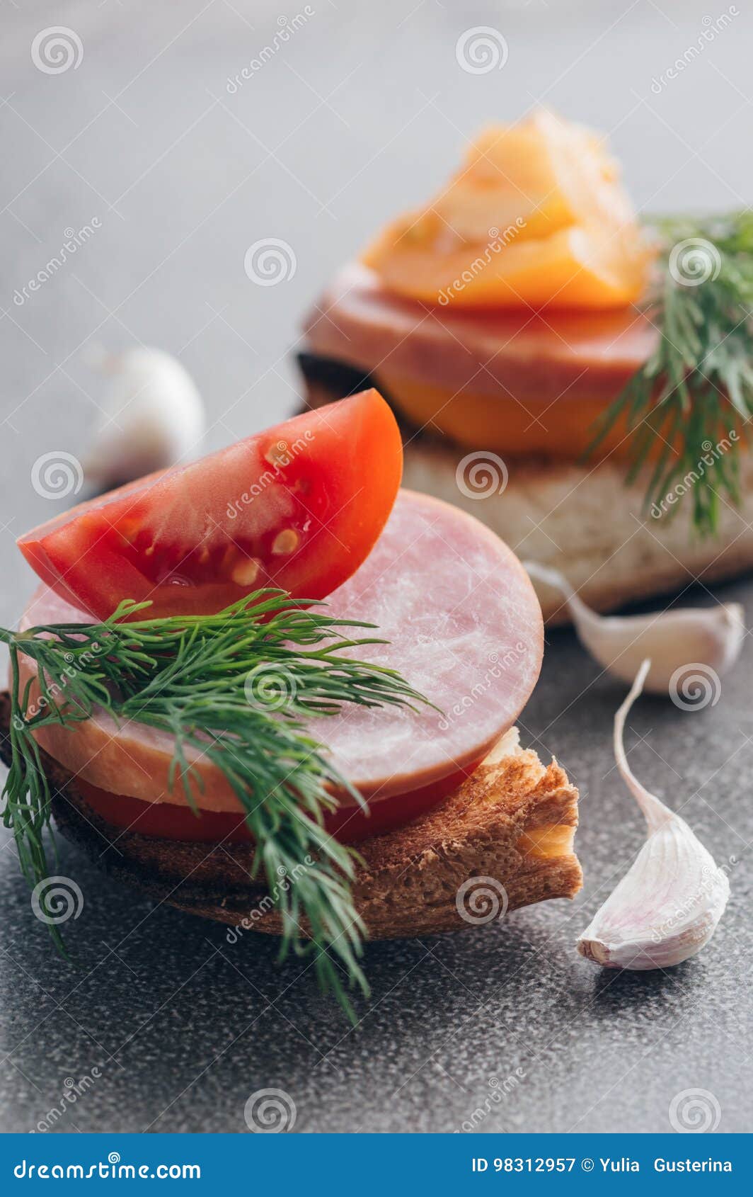 A Ham Sandwich with Red and Yellow Tomatoes on a Gray Surface. Stock ...