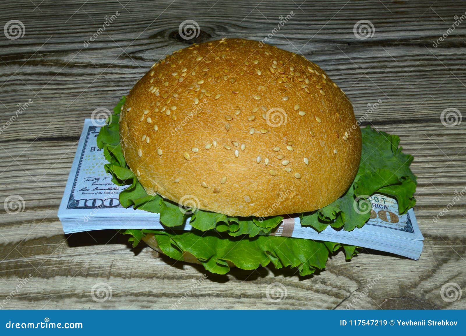 Hamburger with a Bunch of Dollars on a Wooden Table Background Stock ...