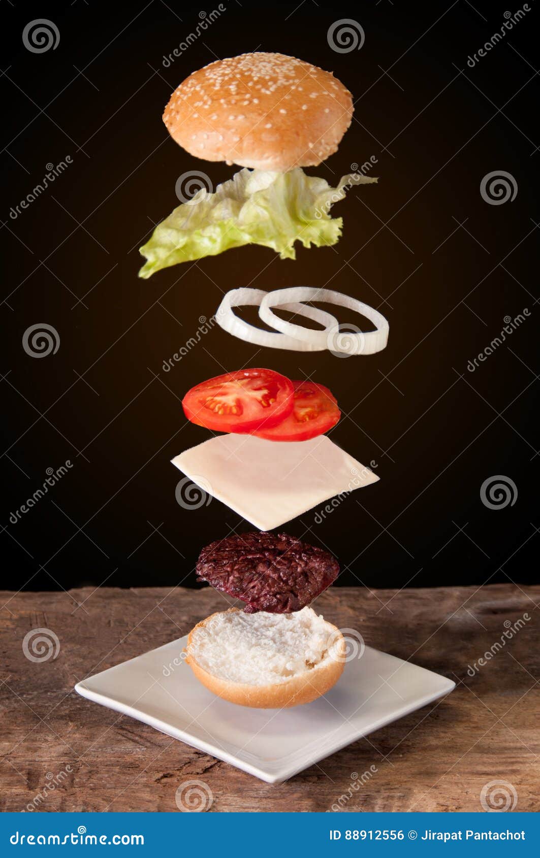 Hamburger with Flying Ingredients Placed on Wooden Planks Stock Photo ...