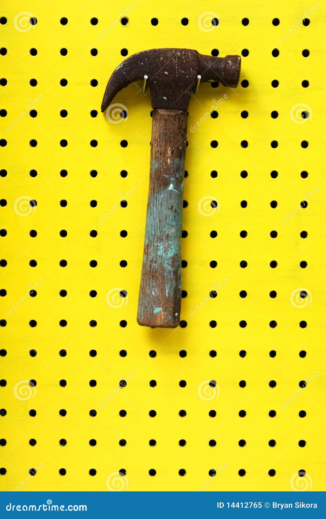 Hammer Hangs on Two Hooks from Yellow Peg Board Stock Image - Image of ...
