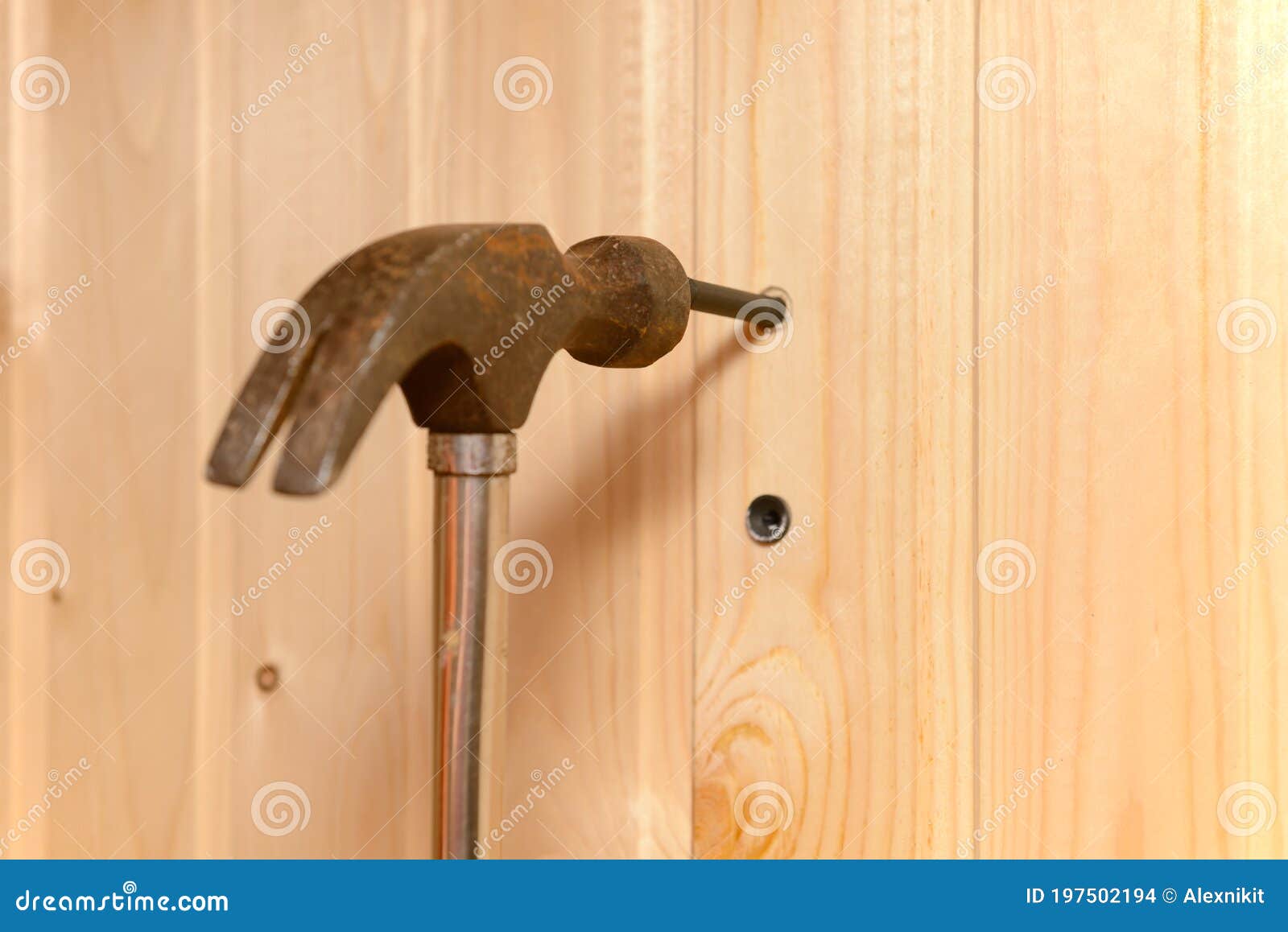 Hammer Hits the Dowel and Hammers it into a Hole in the Wooden Wall ...