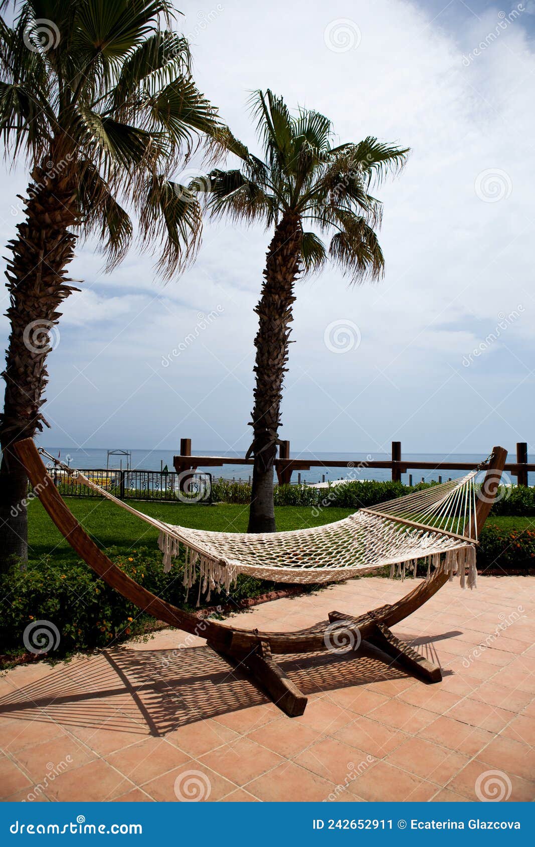 Hammock Under Palm Trees on the Sunny Seashore. Rest and Relaxation ...