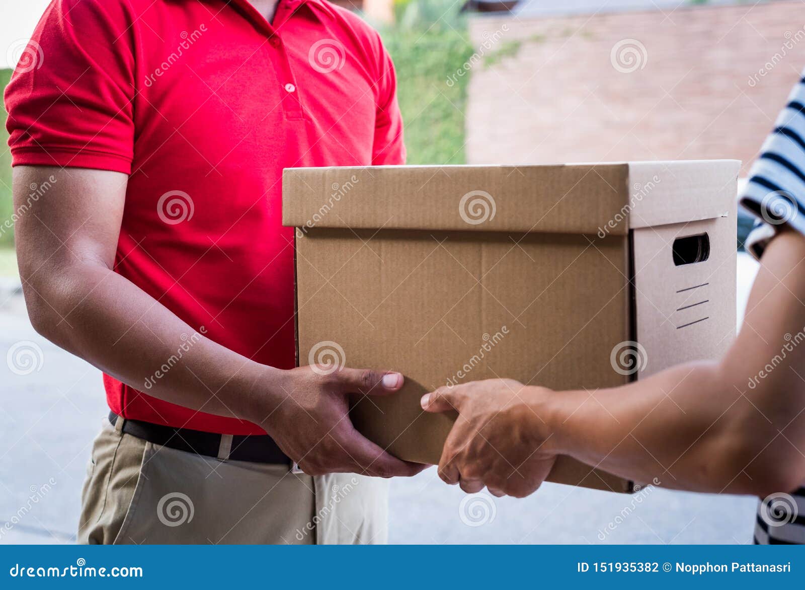 Hand Accepting a Delivery of Boxes from Deliveryman. Stock Photo ...