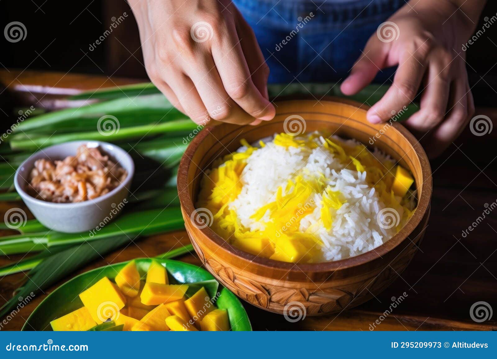 Hand Adding Fresh Mango Chunks To a Bowl of Already Made Sticky Rice ...