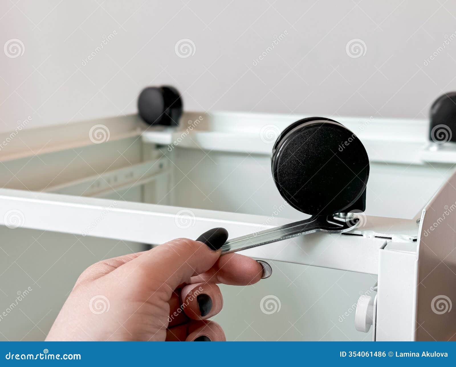 Hand Adjusting Caster Wheels on White Metal Frame Stock Photo - Image ...