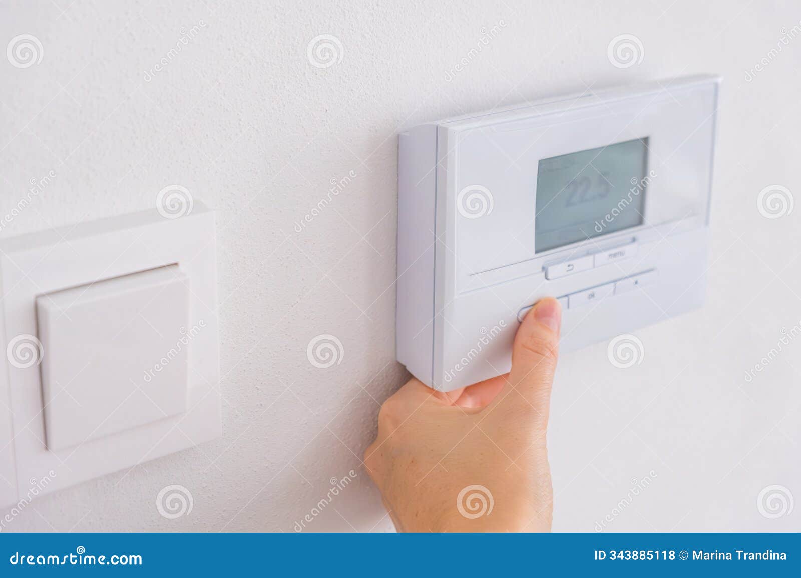Hand Adjusting Digital Thermostat on Wall To Control Room Temperature ...