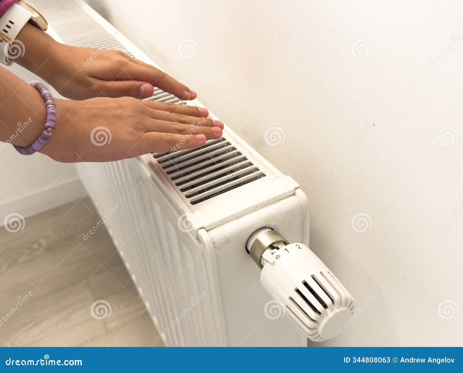 Hand Adjusting Radiator Temperature Using Thermostat. Home with Central ...