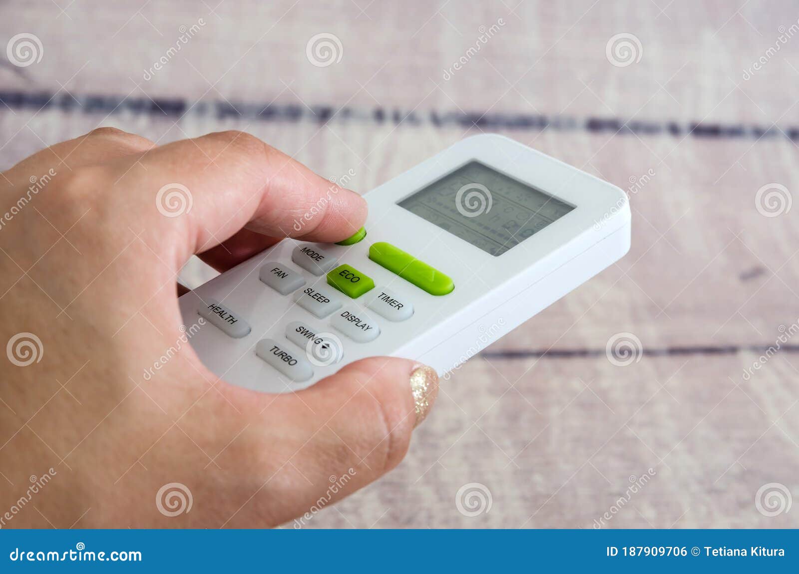 Hand with Air Conditioner Remote Control Adjusting the Air Temperature ...