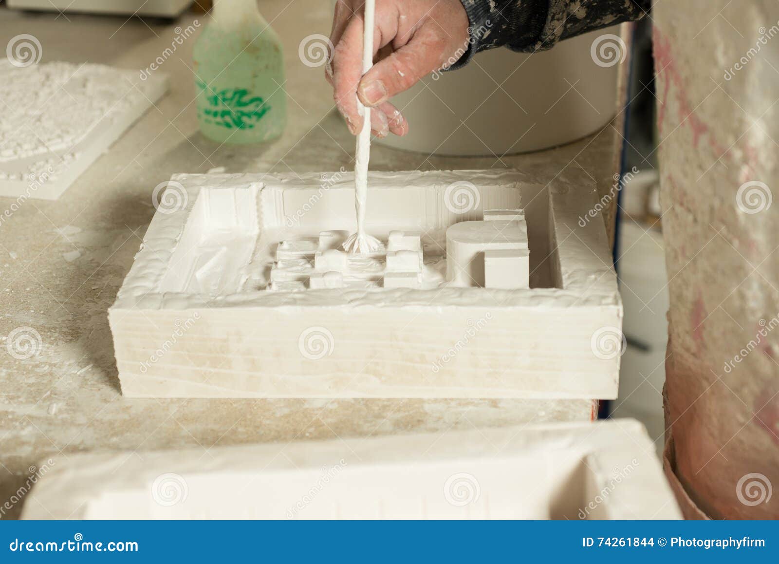 Hand Applying Dab of Plaster on Mold Using Paintbrush Stock Photo ...