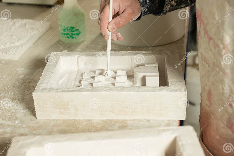 Hand Applying Dab of Plaster on Mold Using Paintbrush Stock Photo ...