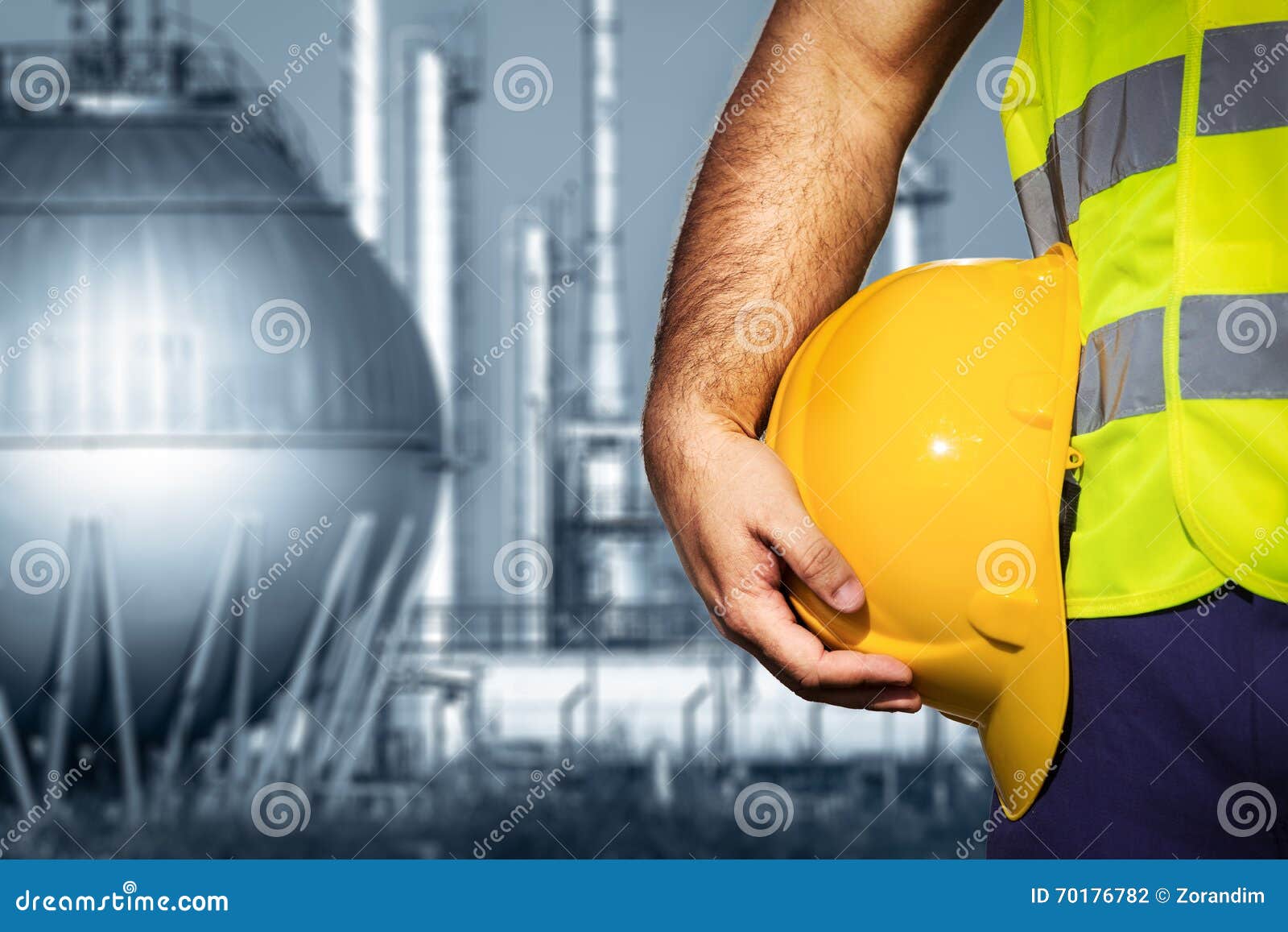 Hand or Arm of Engineer Hold Yellow Plastic Helmet in Front of Oil ...