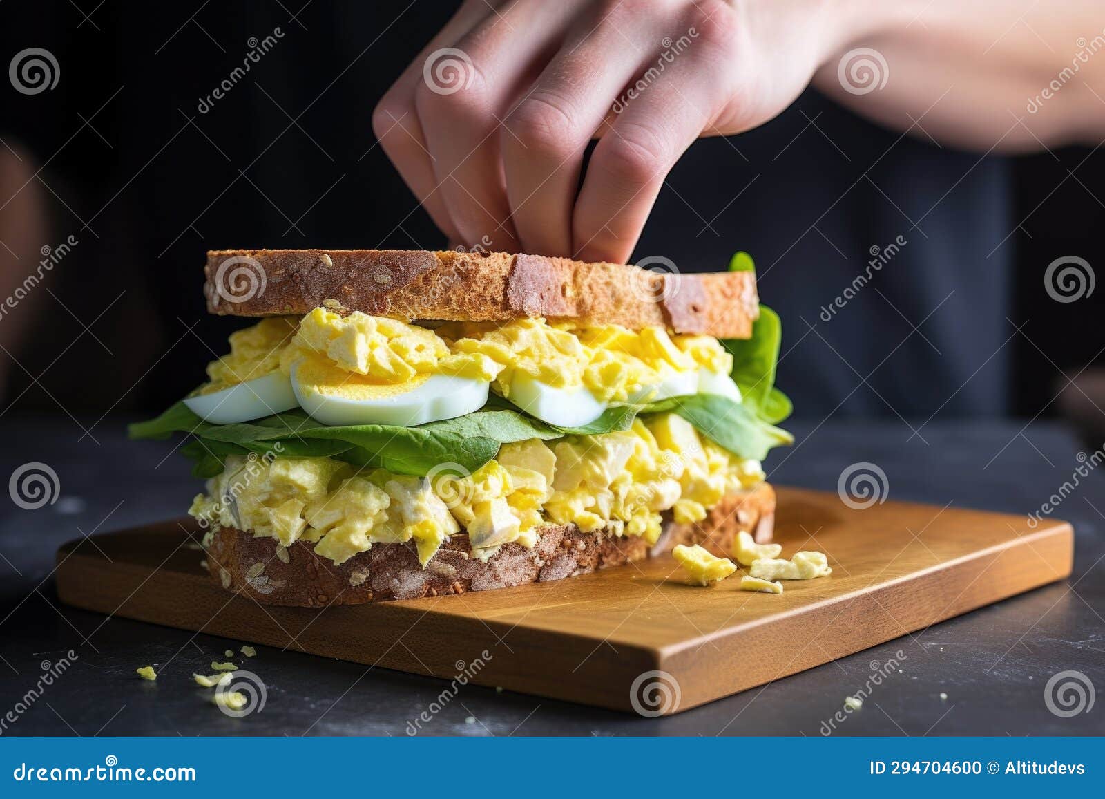 Hand Arranging Egg Salad Over a Crispy Roll Stock Illustration ...
