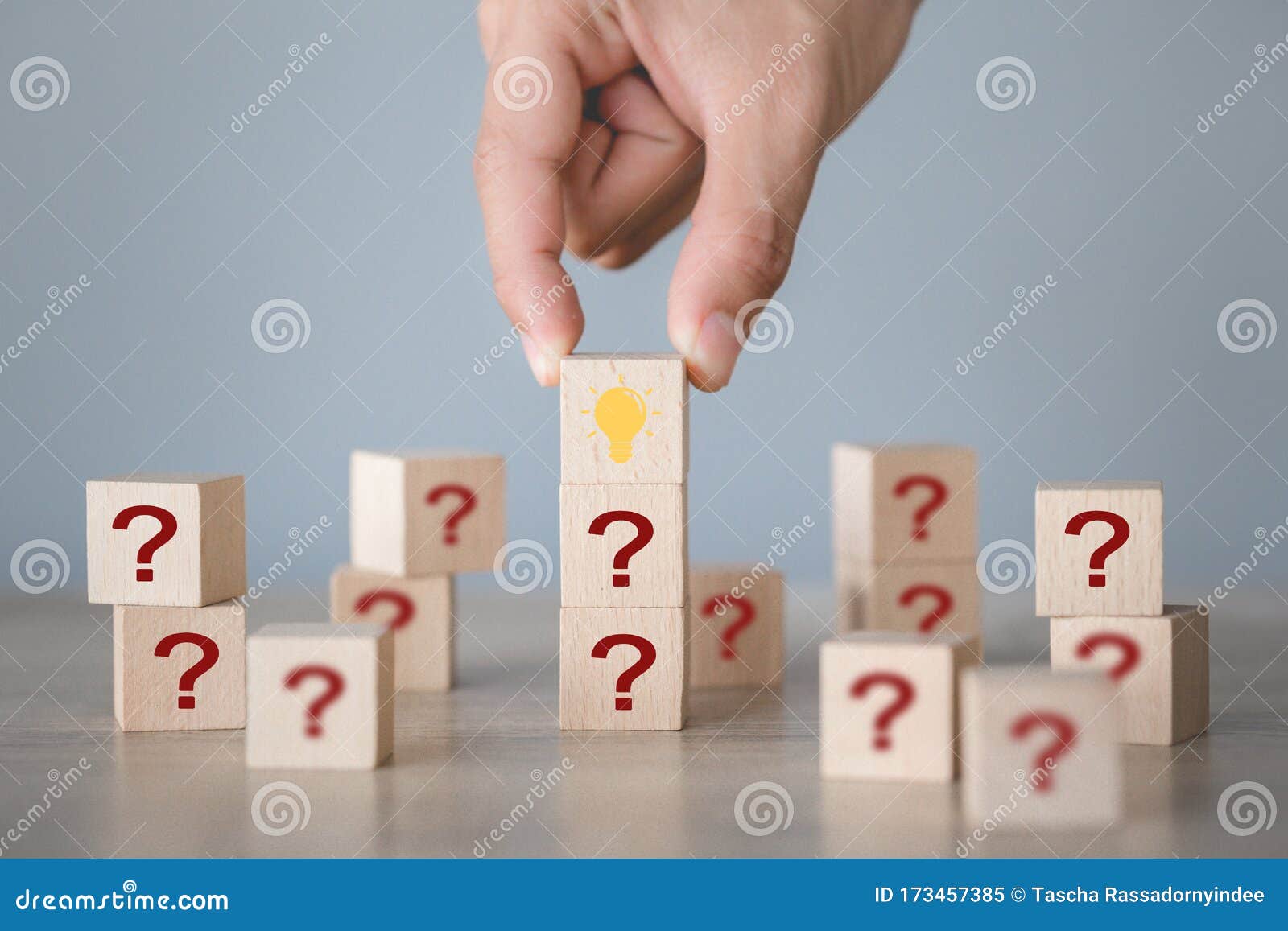 Hand Arranging Wood Block Stacking with Icon Question Mark and Lamp ...