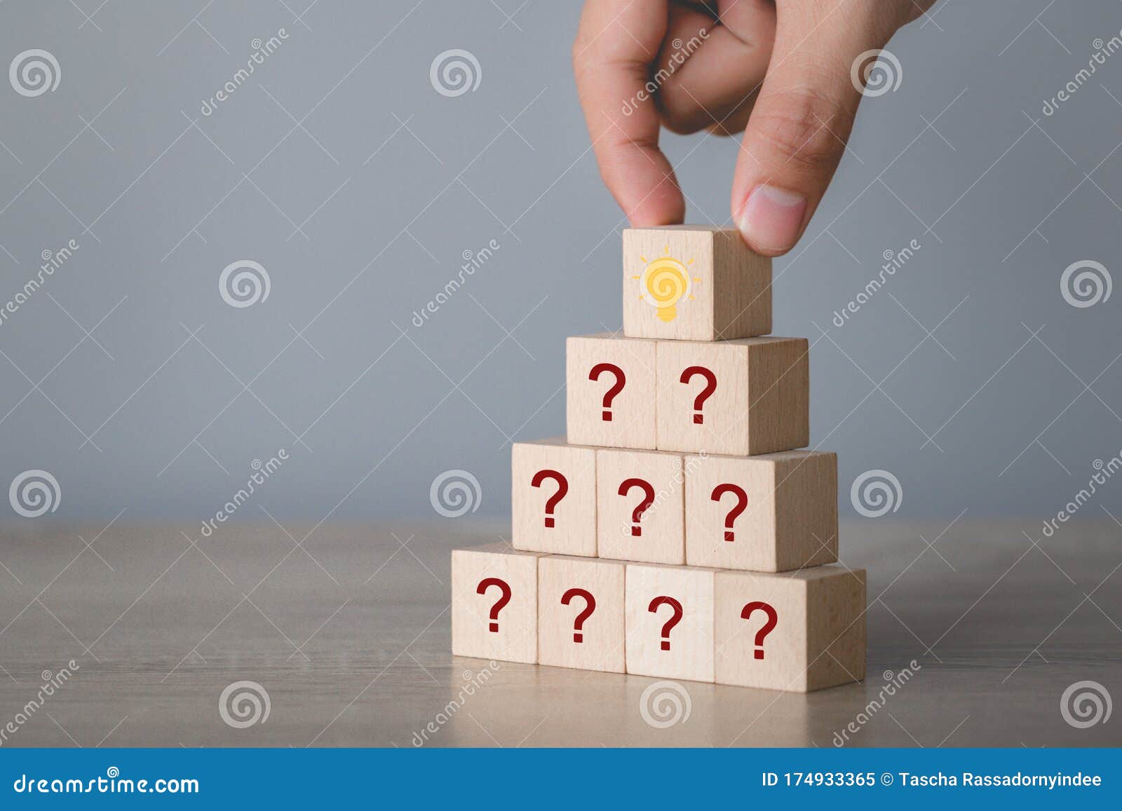 Hand Arranging Wood Block Stacking with Icon Question Mark and Lamp ...