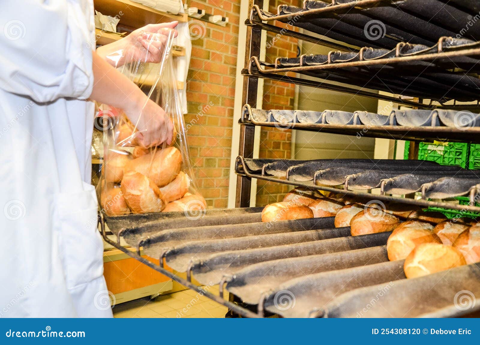 Hand of Baker or Apprentice Baker Taking Baguettes Out of Oven Stock ...