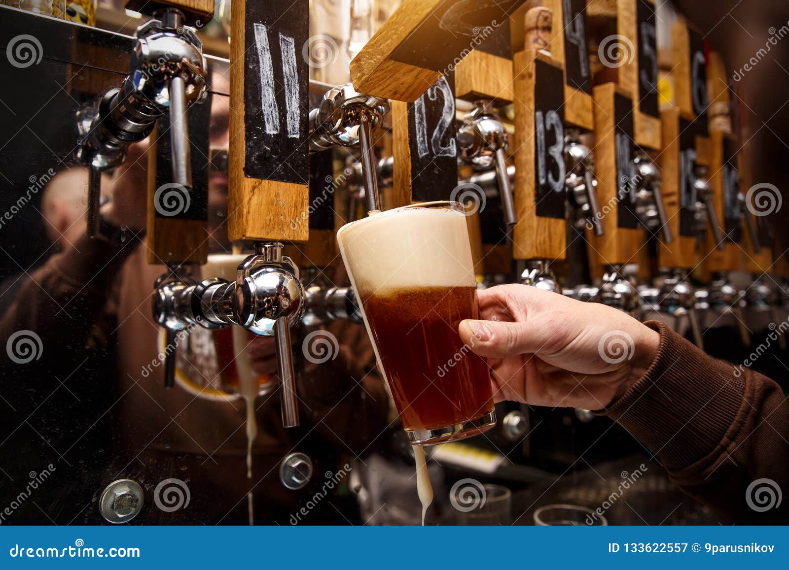 Hand of Bartender Pouring a Red Ale from Tap. Stock Image - Image of ...