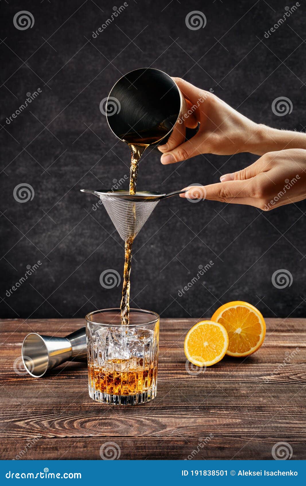 Hand of Bartender with Shaker and Strainer Pouring Cocktail with Brandy ...