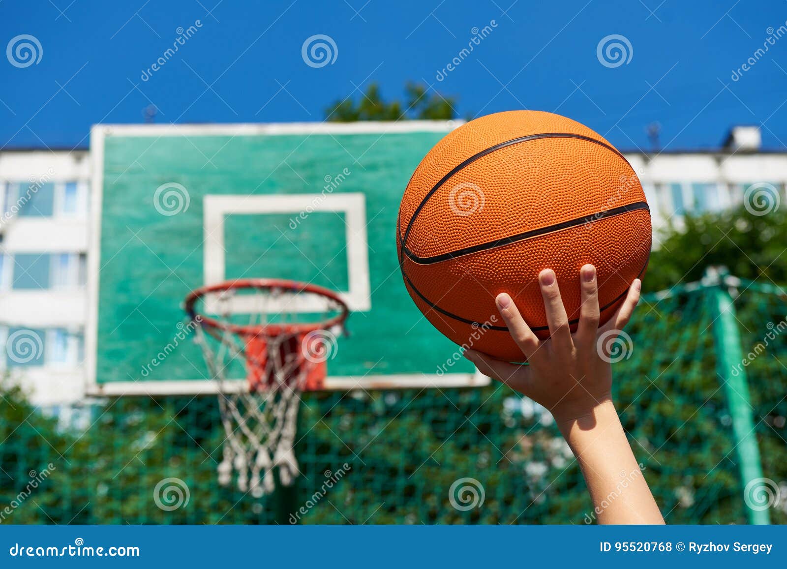 Hand with Basketball on Background of Shield Basket Hoop Stock Photo ...