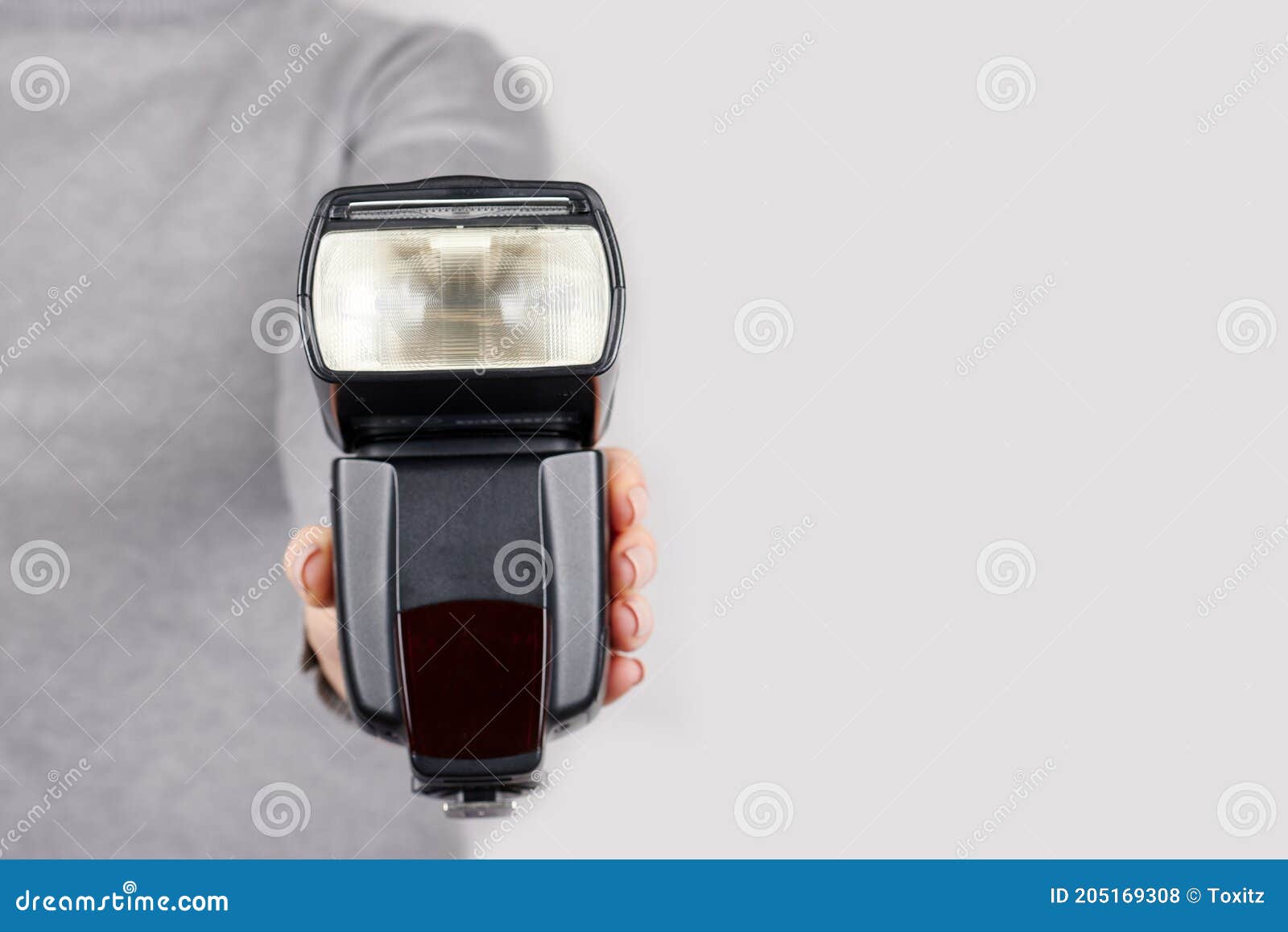 Hand with Black Camera Flash on Grey Background Stock Photo - Image of ...