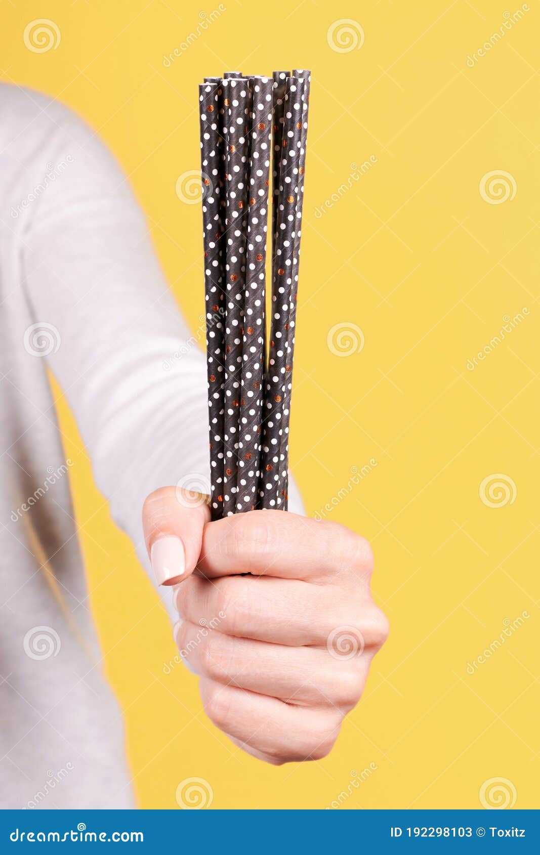 Hand with Black Drinking Straw. Isolated on Yellow Background Stock ...