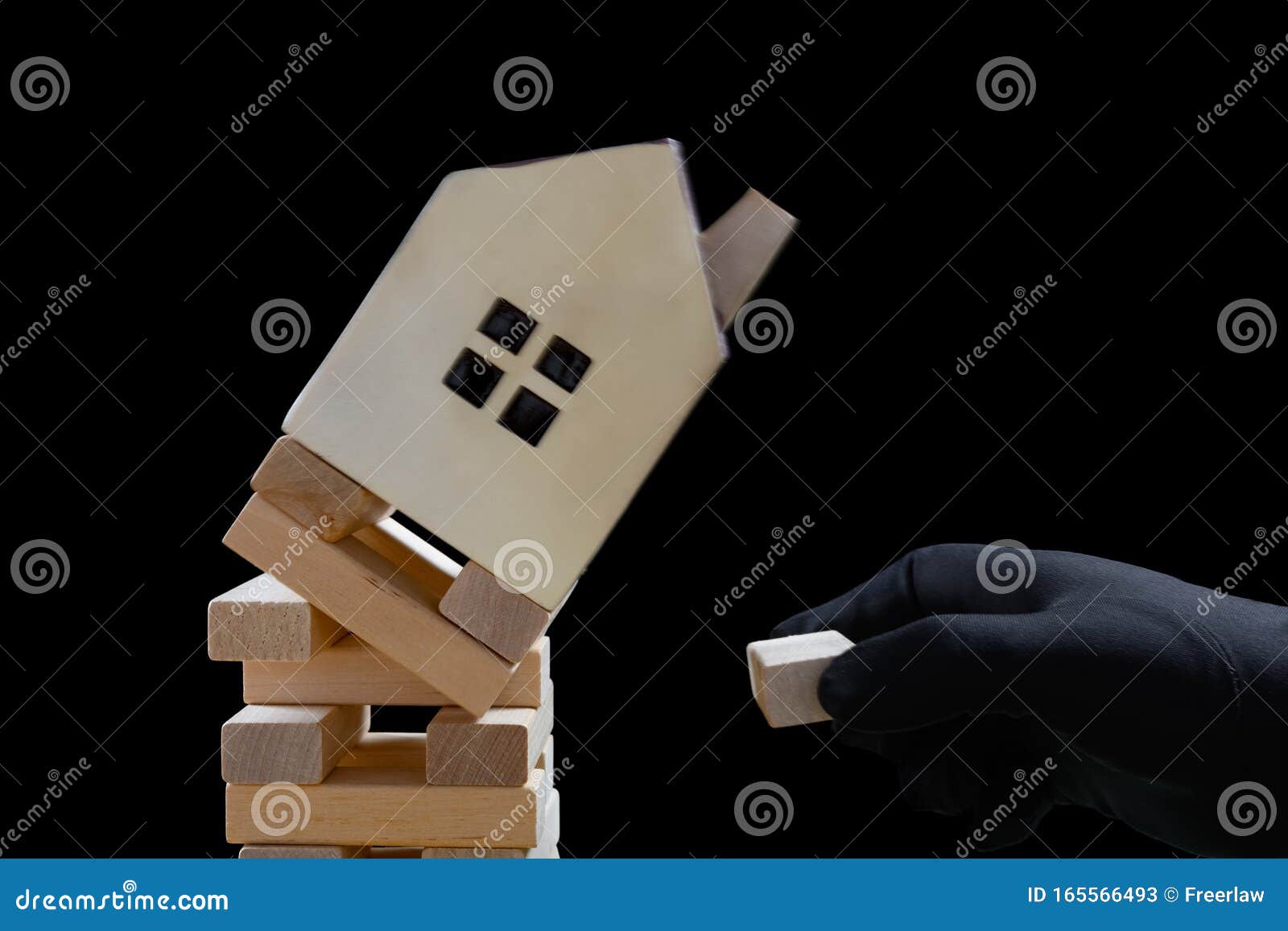 Hand with Black Glove Damaging the Foundation of a House and the House ...