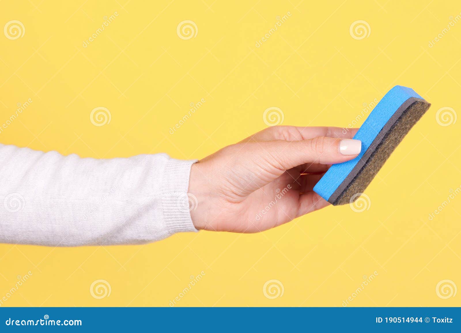 Hand with Board Eraser. Isolated on Yellow Background Stock Photo ...