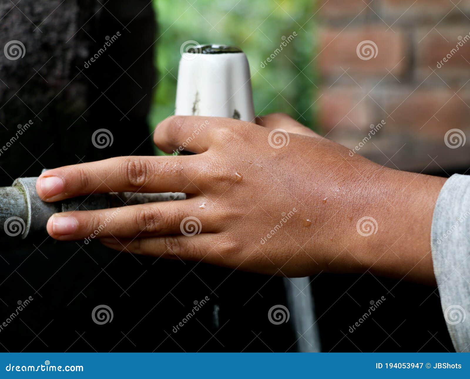 Hand of a Boy Turning on an Old Plastic Water Tap Stock Image - Image ...