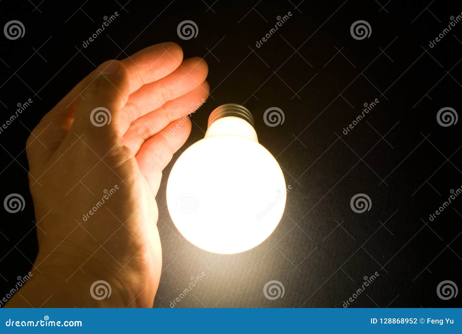 Hand and a Bright Light Bulb Stock Photo - Image of smart, lightbulb ...