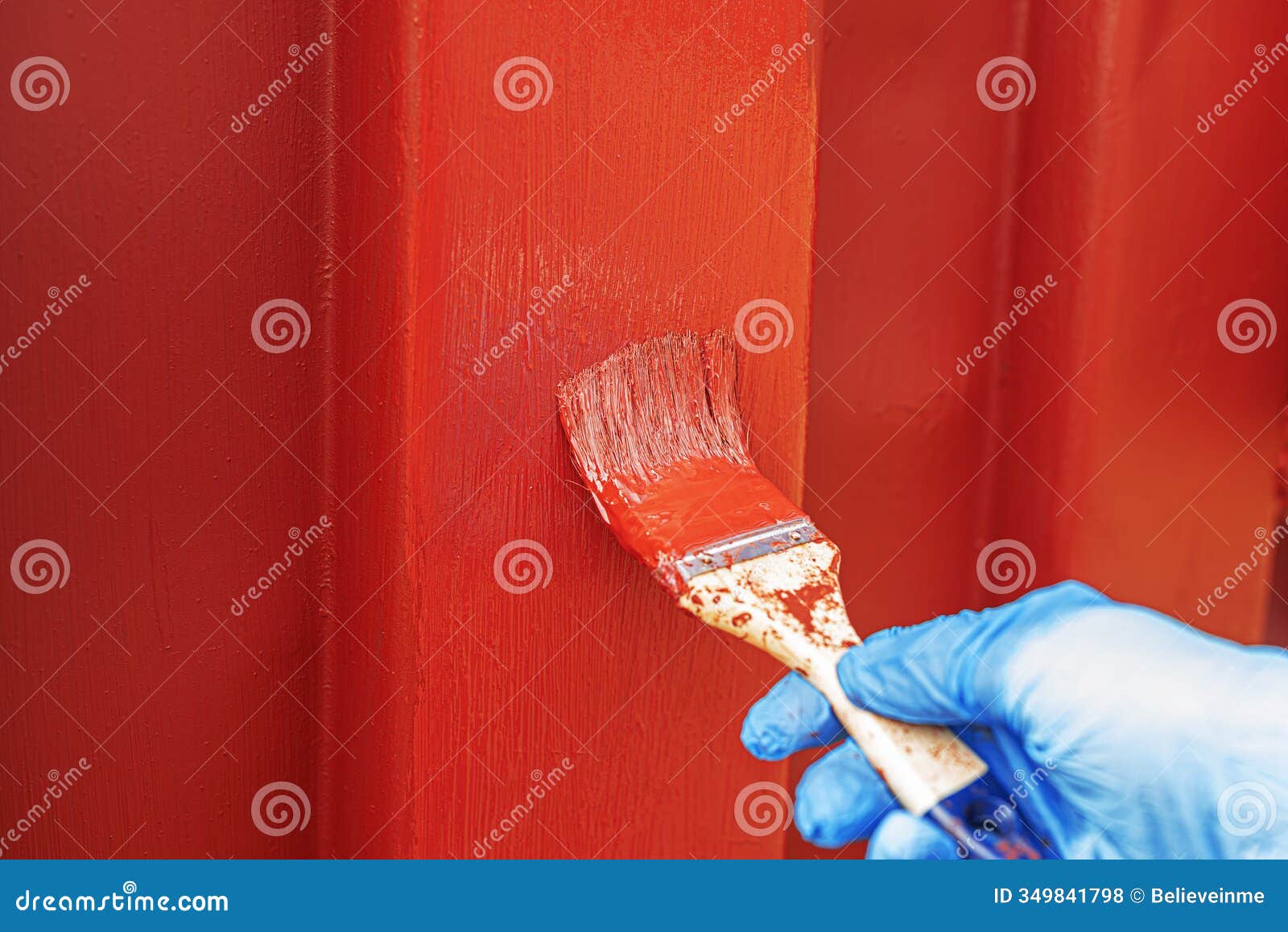 A Hand with a Brush Paints an Old Iron Surface with Paint. Stock Photo ...
