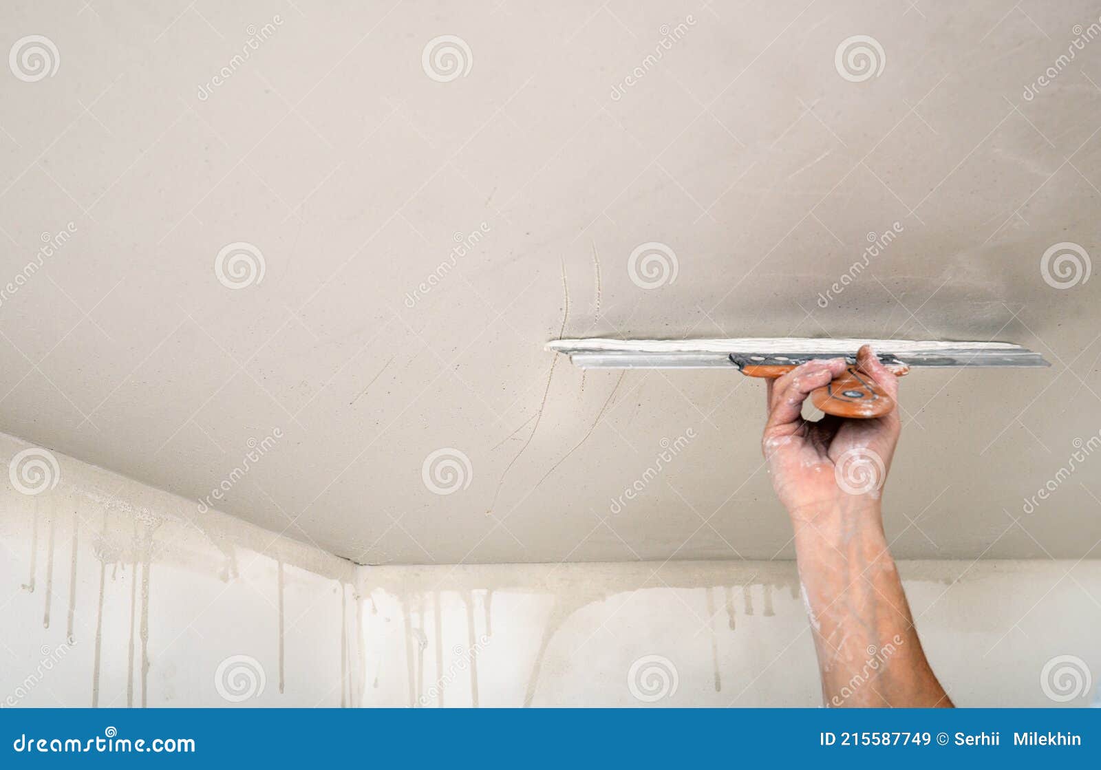 Hand of Builder Worker Spacks Ceiling with Putty Plaster Aligning ...