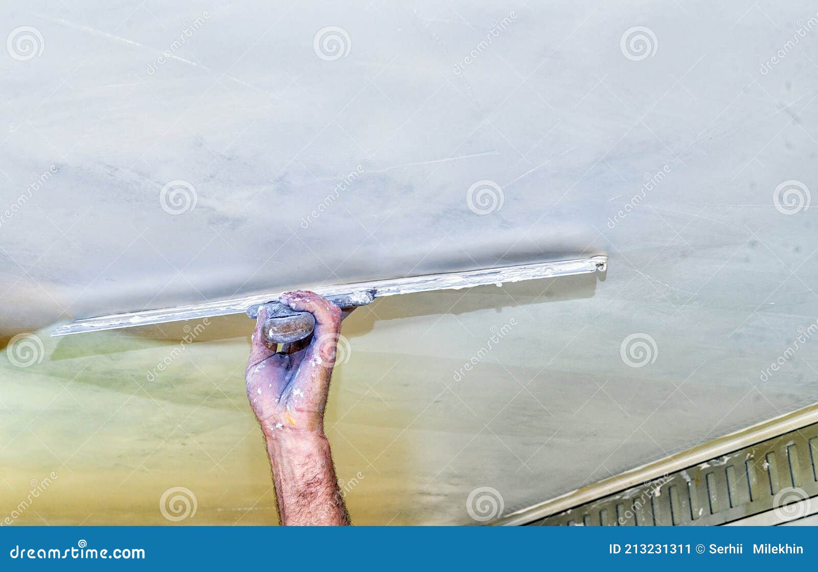 Hand of Builder Worker Spacks Ceiling with Putty Plaster Aligning ...