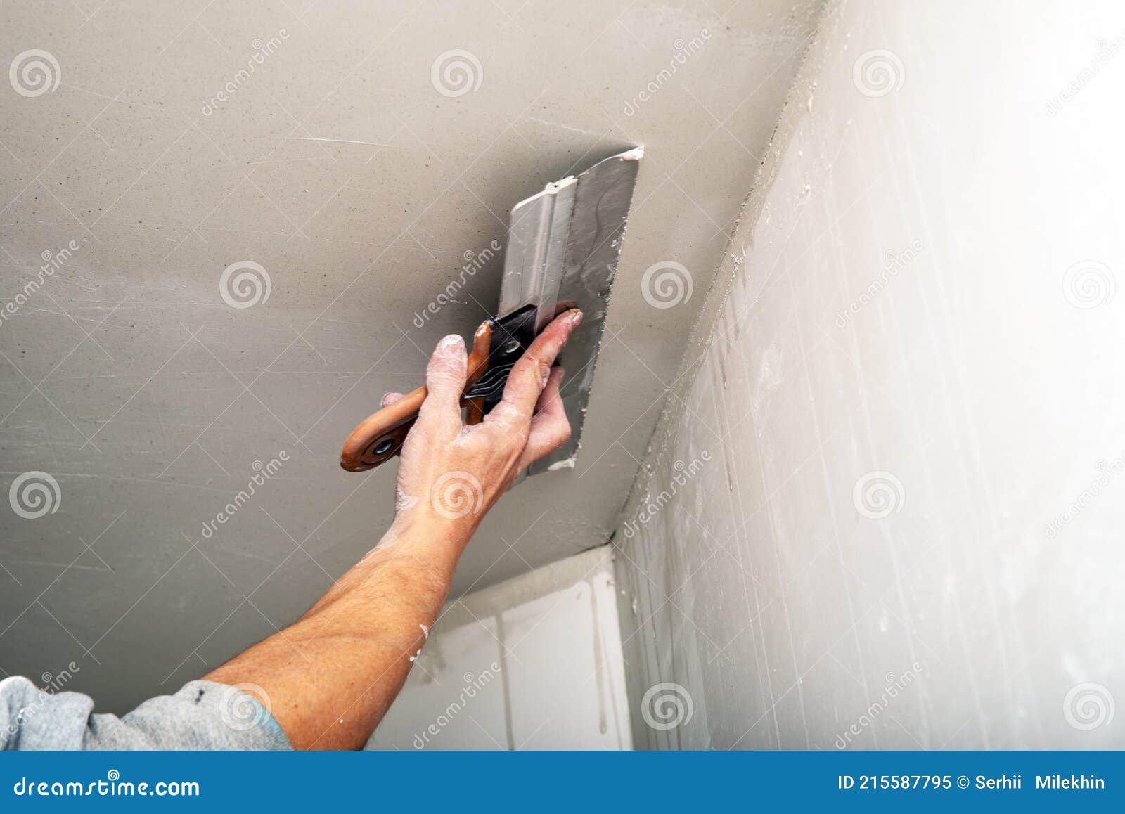 Hand of Builder Worker Spacks Ceiling with Putty Plaster Aligning ...
