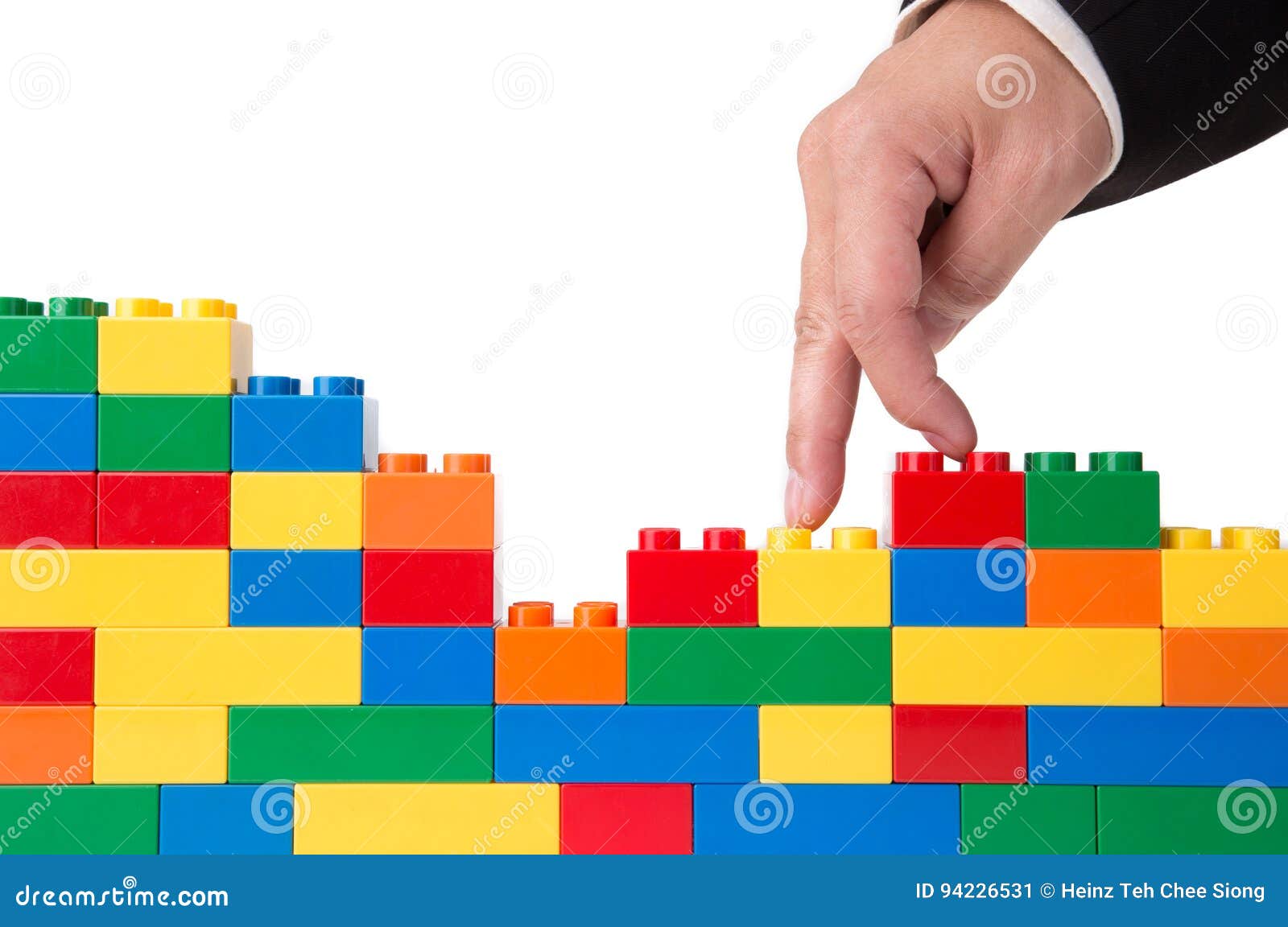 Hand building up a block stock image. Image of game, human - 94226531