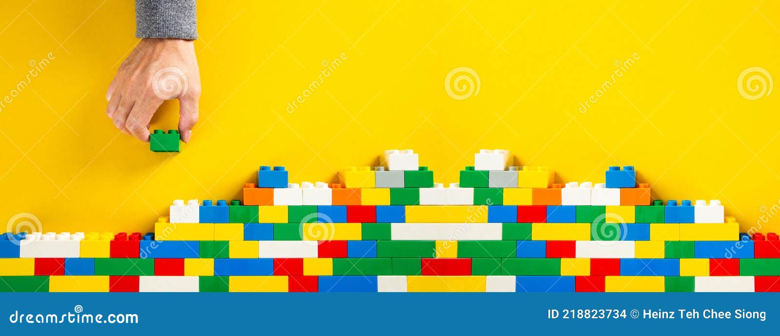 Hand Building Up a Wall by Stacking Up Plastic Block Stock Photo ...